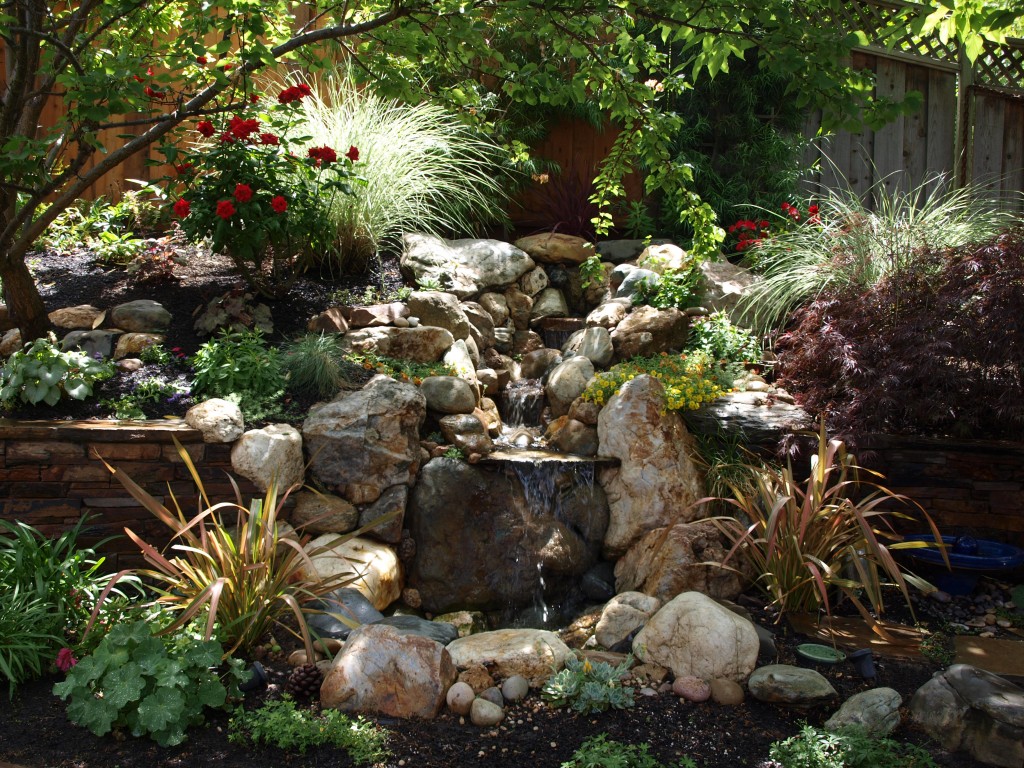 Specialty boulder cascading waterfall | Outer Visions Landscape Design